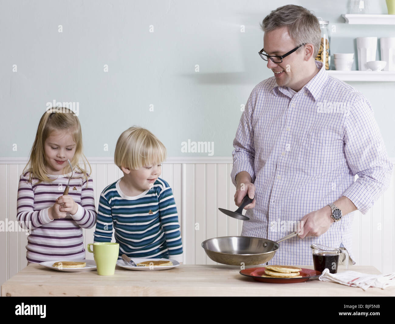 father and children making breakfast Stock Photo - Alamy