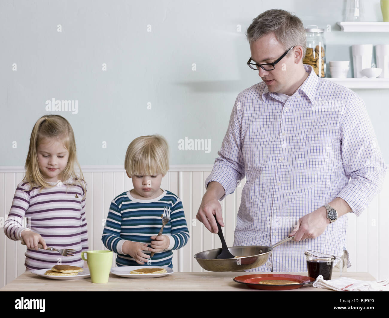 father and children making breakfast Stock Photo - Alamy