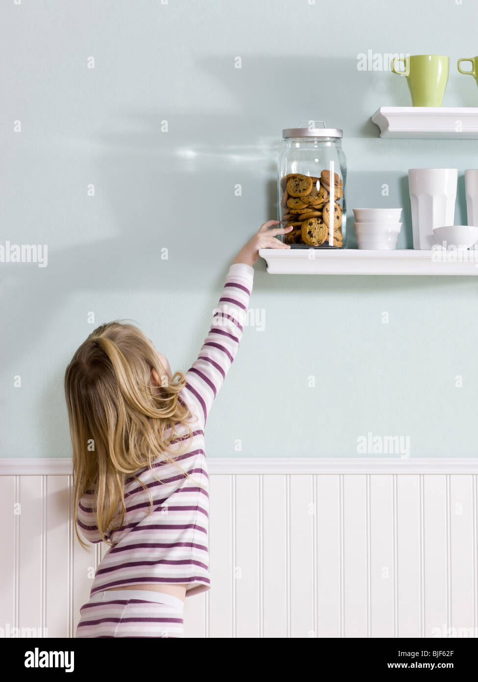 little girl reaching for a cookie jar Stock Photo - Alamy