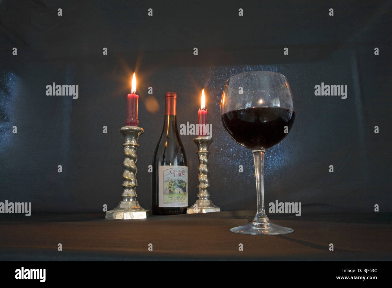 burning candles, a glass of red pino noir wine, in a romantic situation ...