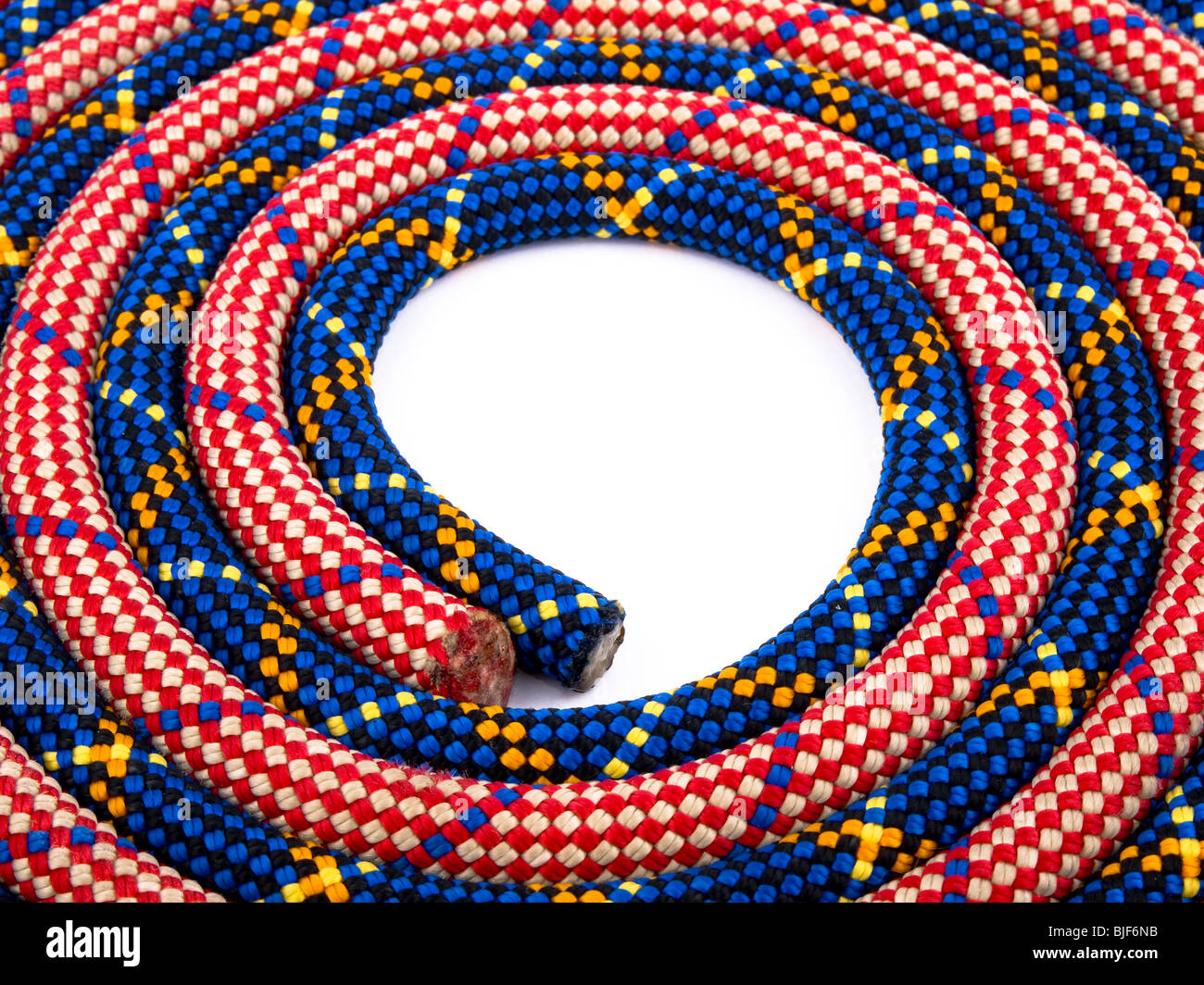 Coil of climbing rope with empty white space in the middle of picture ...
