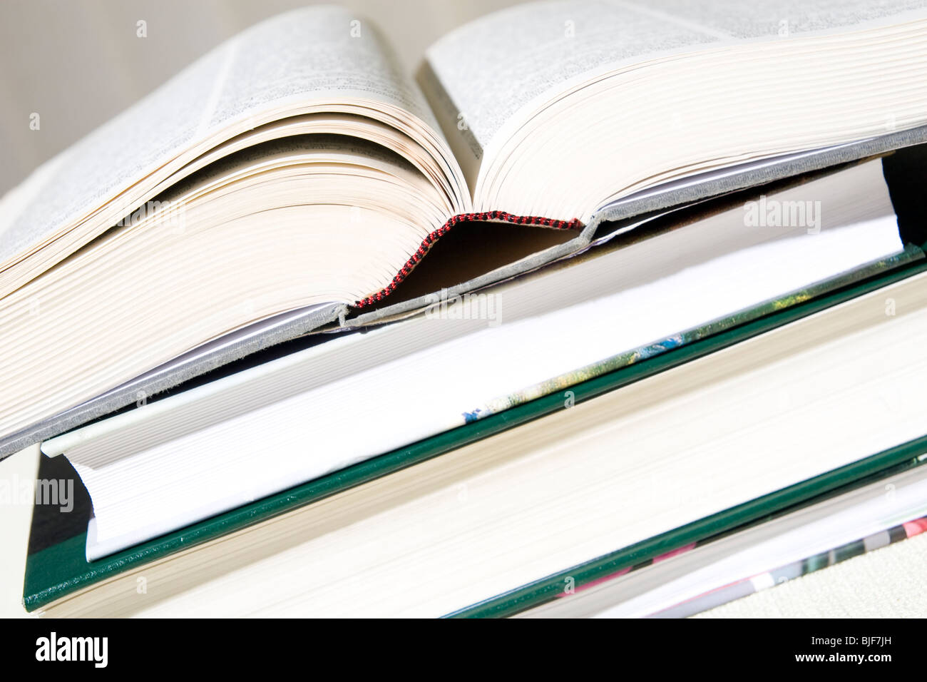 Book opened. Pile of books. Blue toning Stock Photo - Alamy