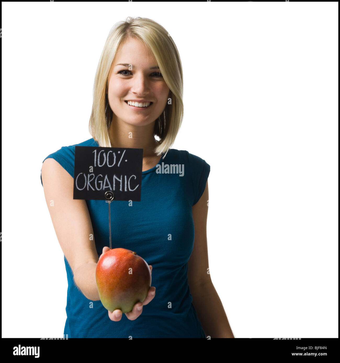 woman holding an organic mango Stock Photo - Alamy