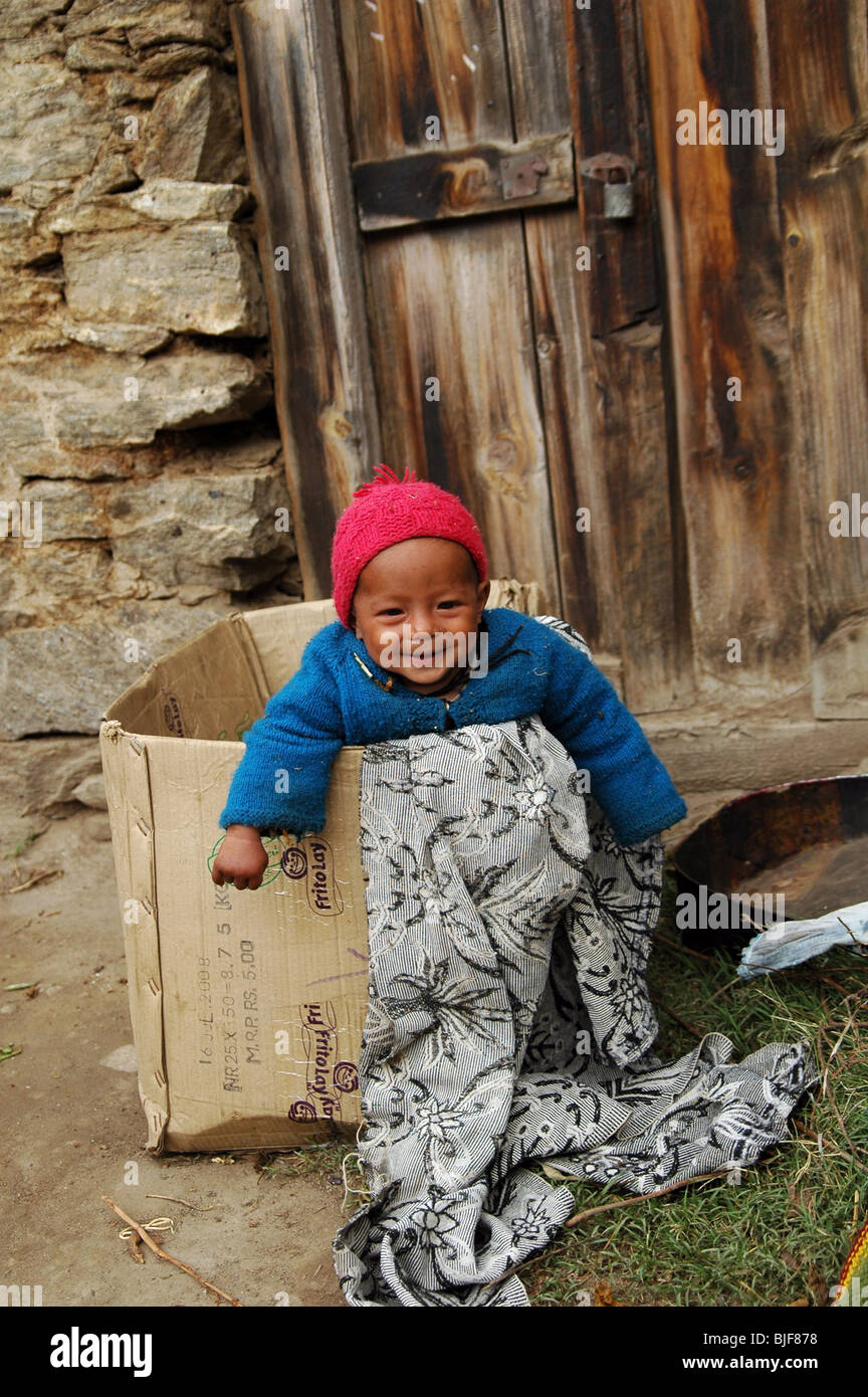 Baby happily standing in Frito lay carton Stock Photo - Alamy