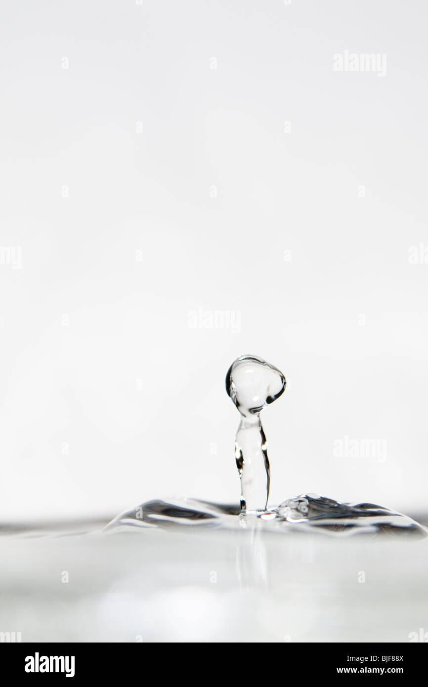 High speed photograph of a water droplet bouncing off a flat water ...
