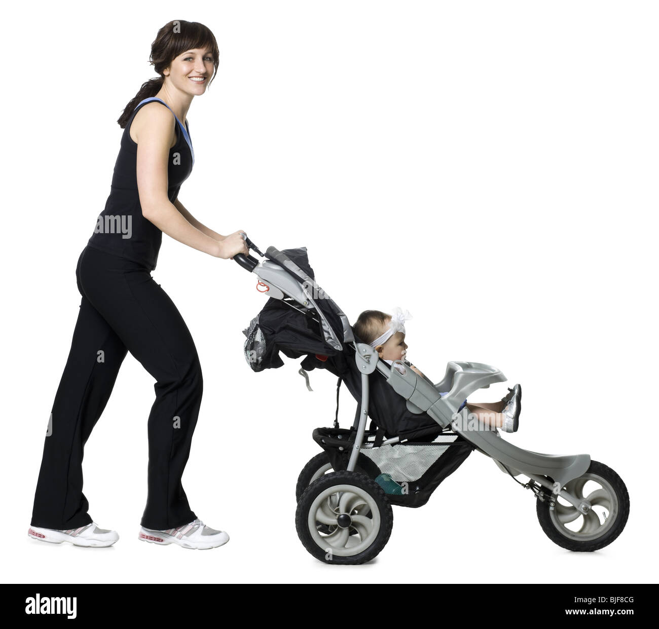 woman pushing her baby in a stroller Stock Photo - Alamy