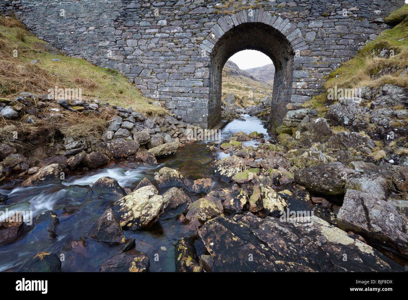 arched stone bridge crossing mountain stream Stock Photo - Alamy
