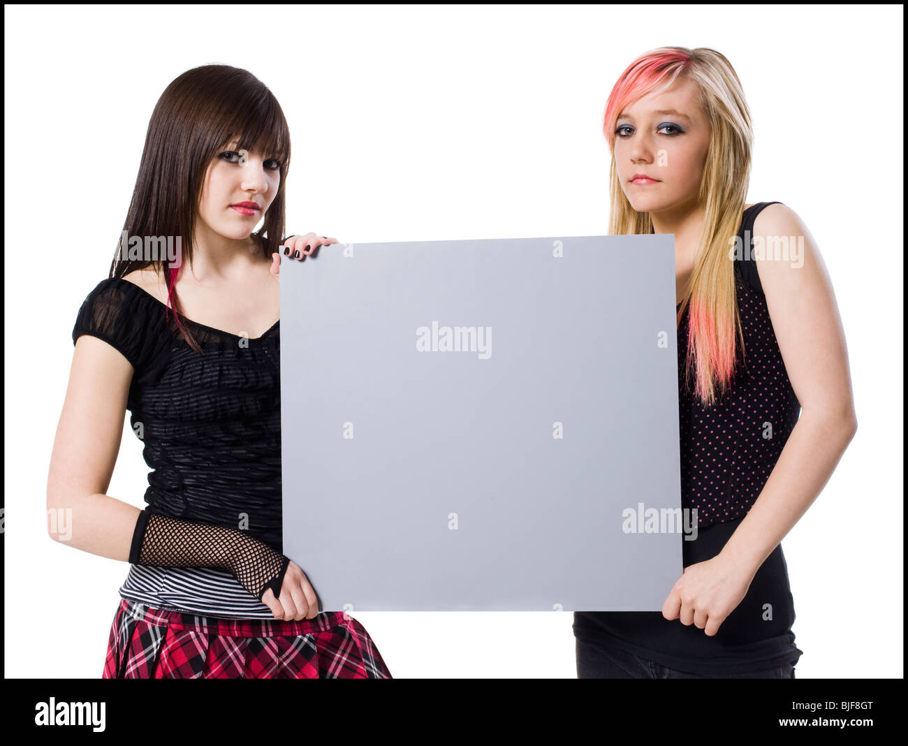 two rocker girls holding a sign Stock Photo - Alamy