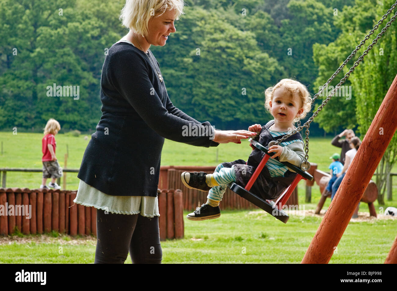 Child pushed on swing hi-res stock photography and images - Alamy