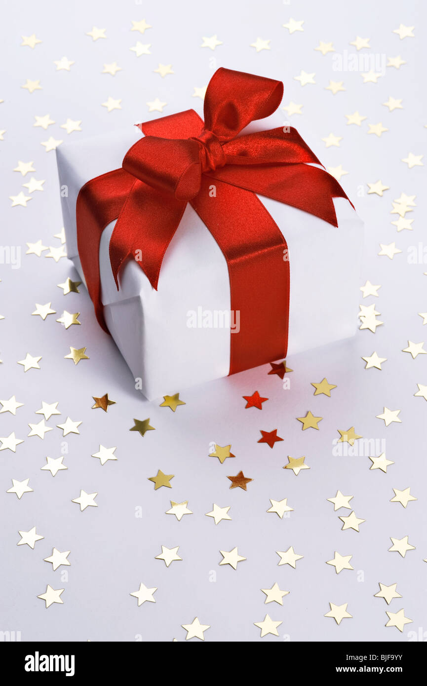 gift with decorative red ribbon on stars background Stock Photo - Alamy