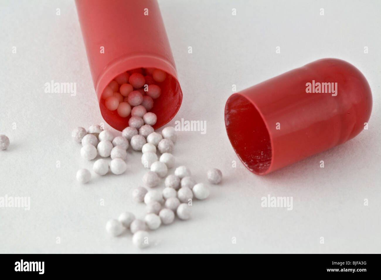 Contents of one capsule red isolated on white background Stock Photo ...