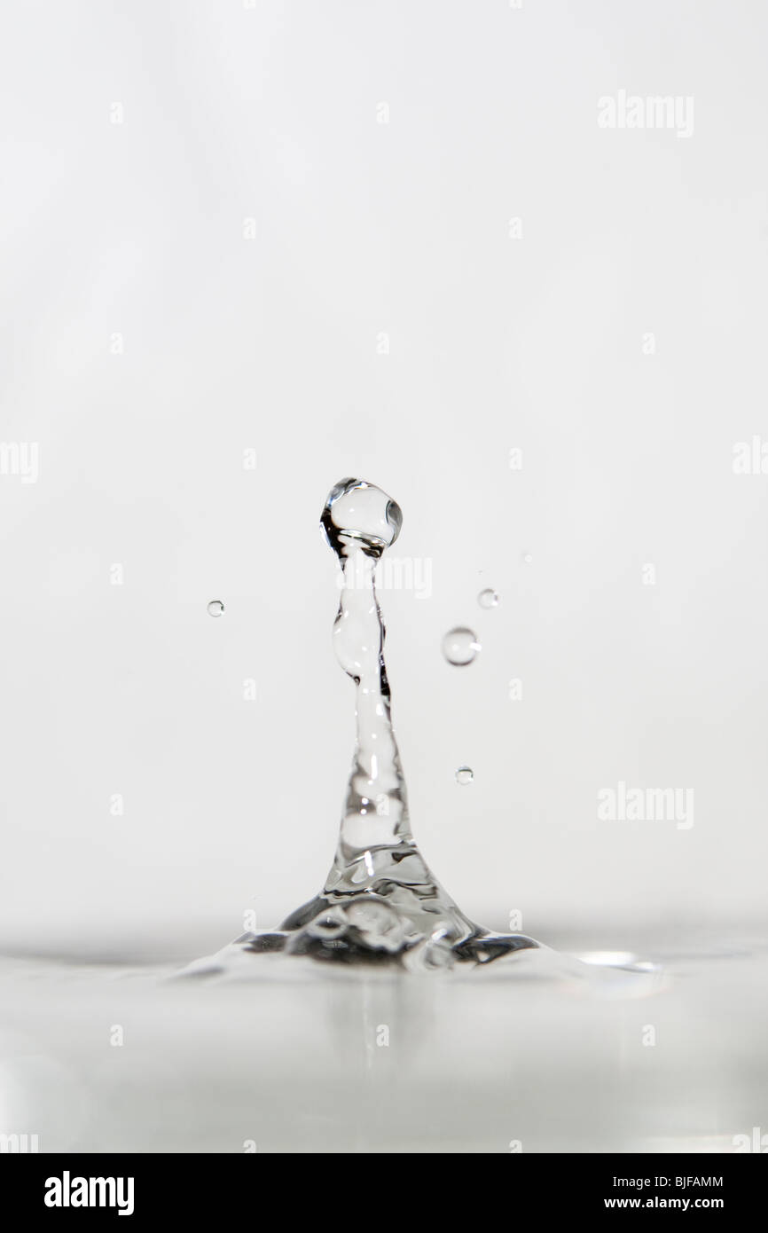 High speed photograph of a water droplet bouncing off a flat water ...
