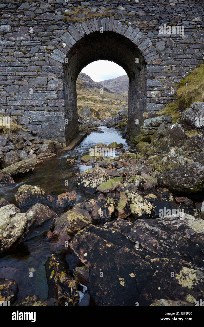 arched stone bridge crossing mountain stream Stock Photo - Alamy