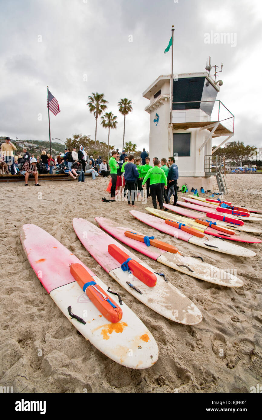 Wet-suited lifeguards (background) gather to support spring tryouts for ...