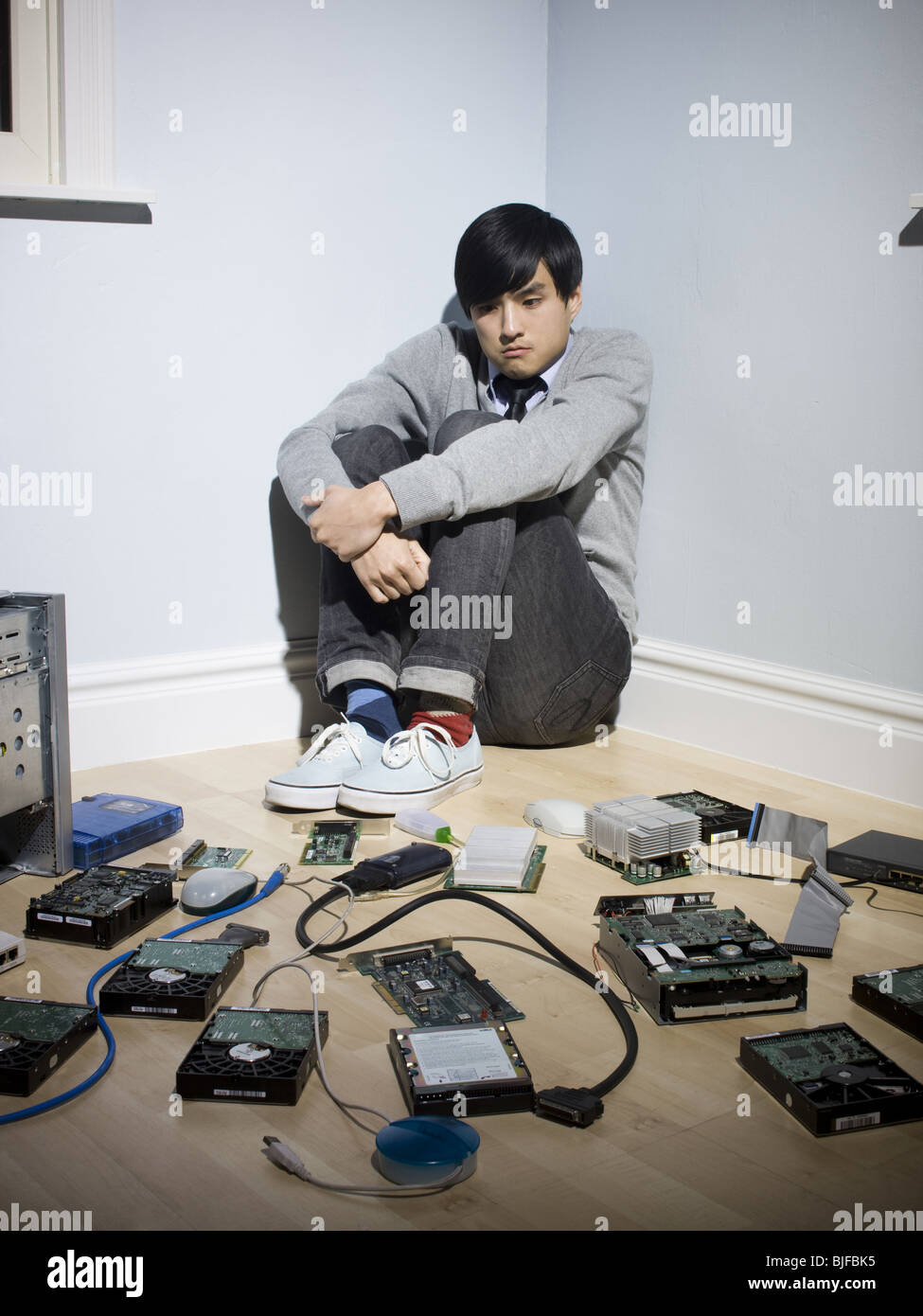 man in the corner surrounded by computer parts Stock Photo - Alamy