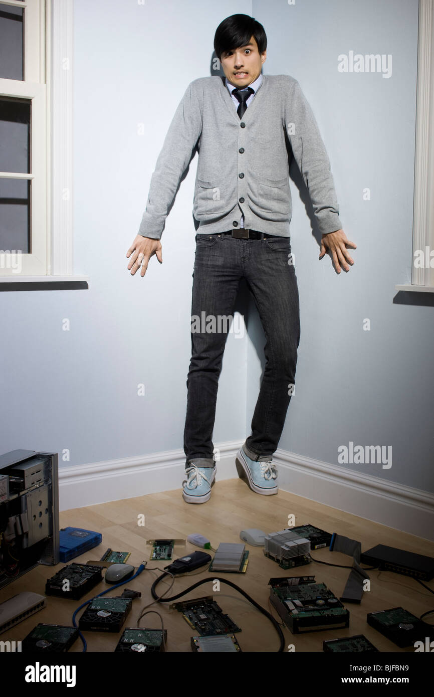 man in the corner surrounded by computer parts Stock Photo - Alamy