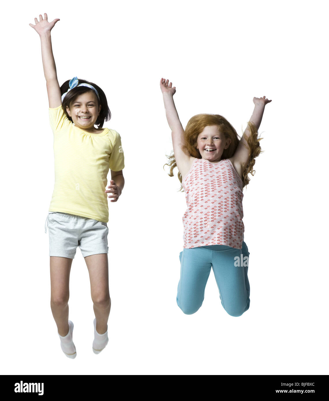 two girls jumping Stock Photo - Alamy