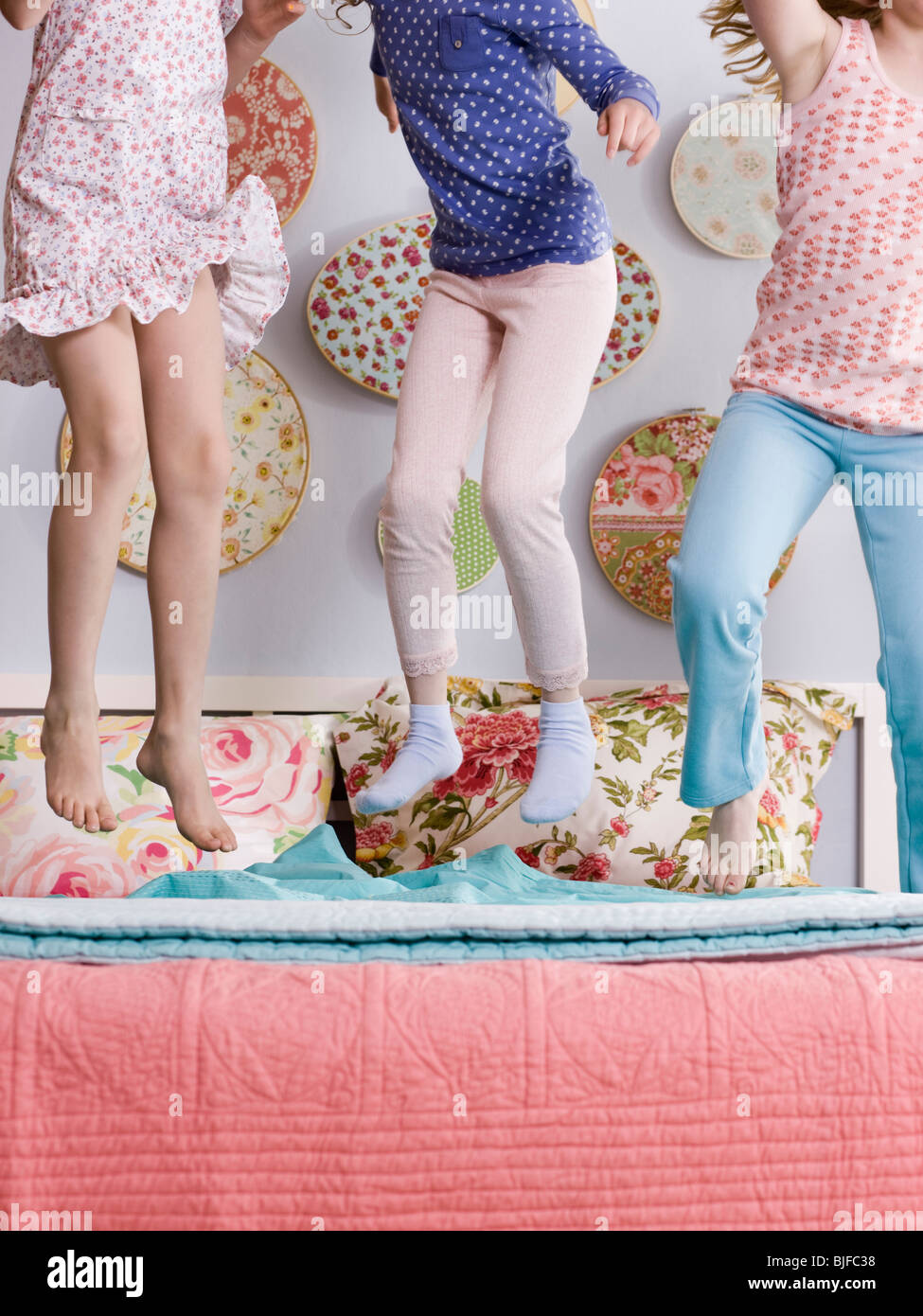 three girls jumping on a bed Stock Photo - Alamy