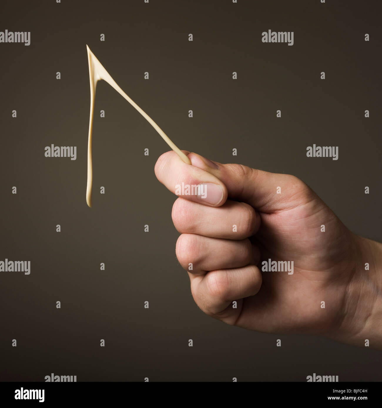 Hand holding a wishbone Stock Photo - Alamy