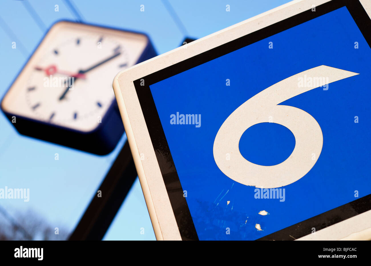 A station clock and sign on a platform at a Dutch railway station Stock ...