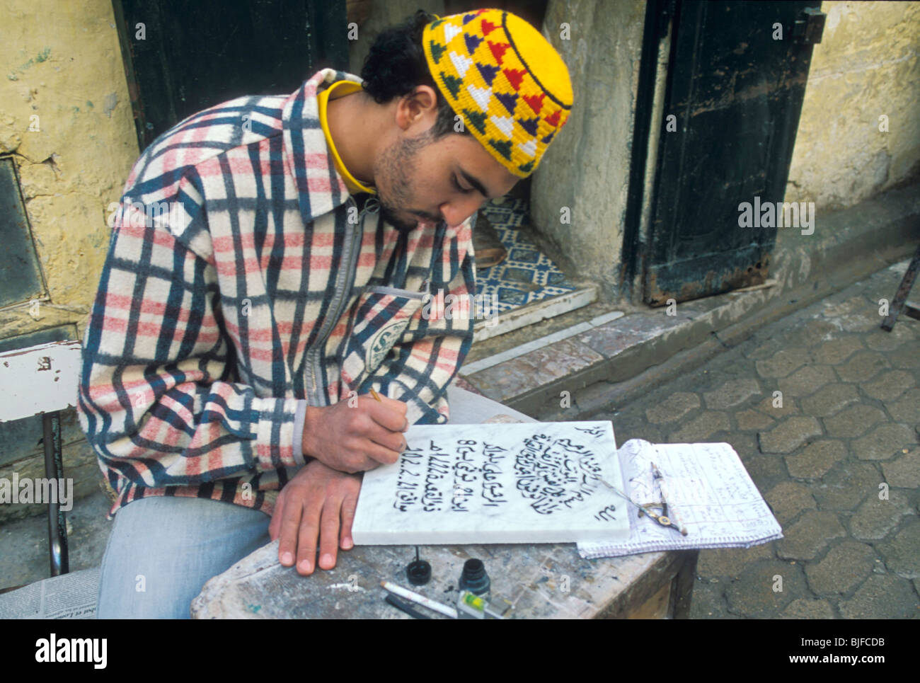MOROCCO MAN WRITING A TABLET IN ARABIC IN THE STREETS OF RABAT Stock ...