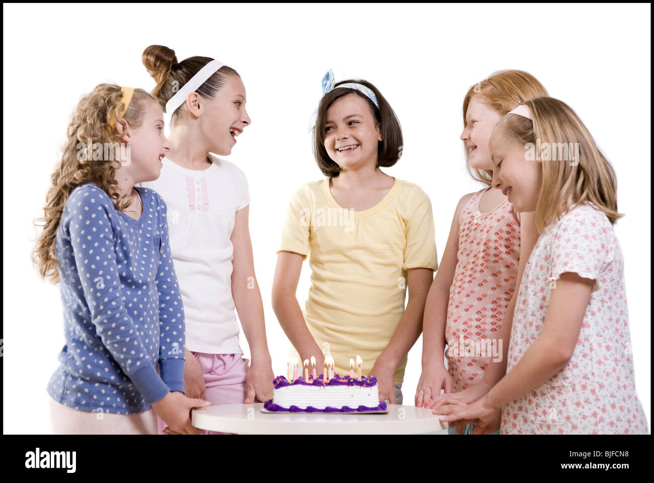 five girls around a birthday cake Stock Photo - Alamy