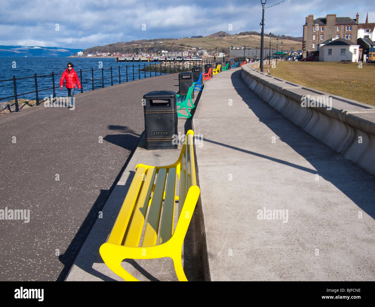 Woman in Red Jacket Walking Past Brightly Coloured Benches at Largs ...