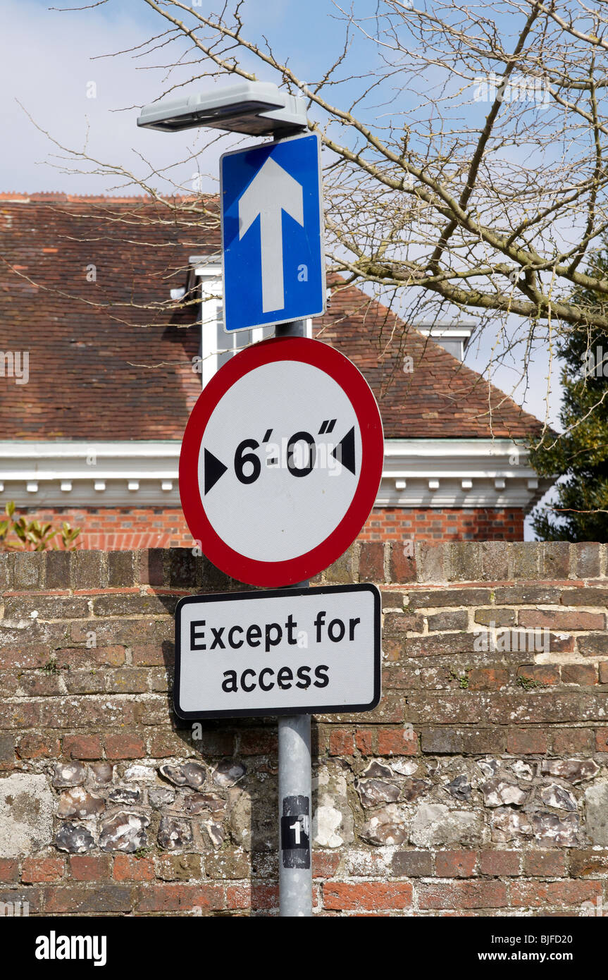 Road signs showing one way street, width restriction and access ...
