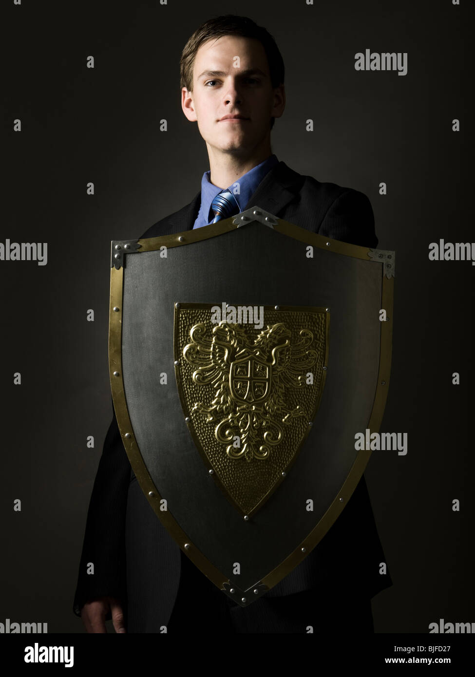 businessman holding a shield Stock Photo - Alamy