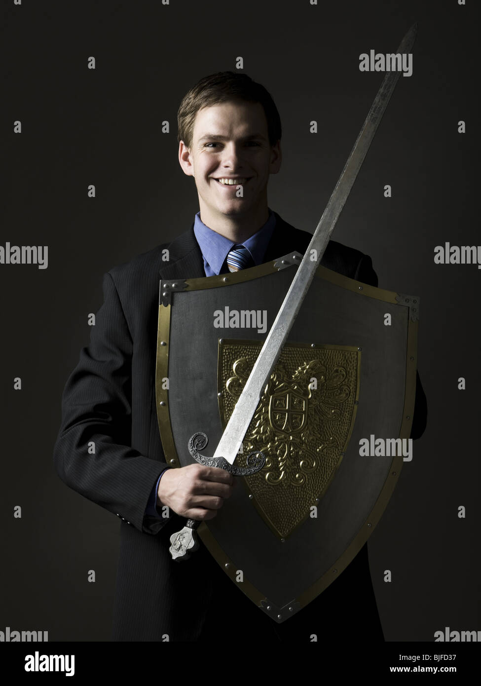 businessman holding a sword and shield Stock Photo - Alamy