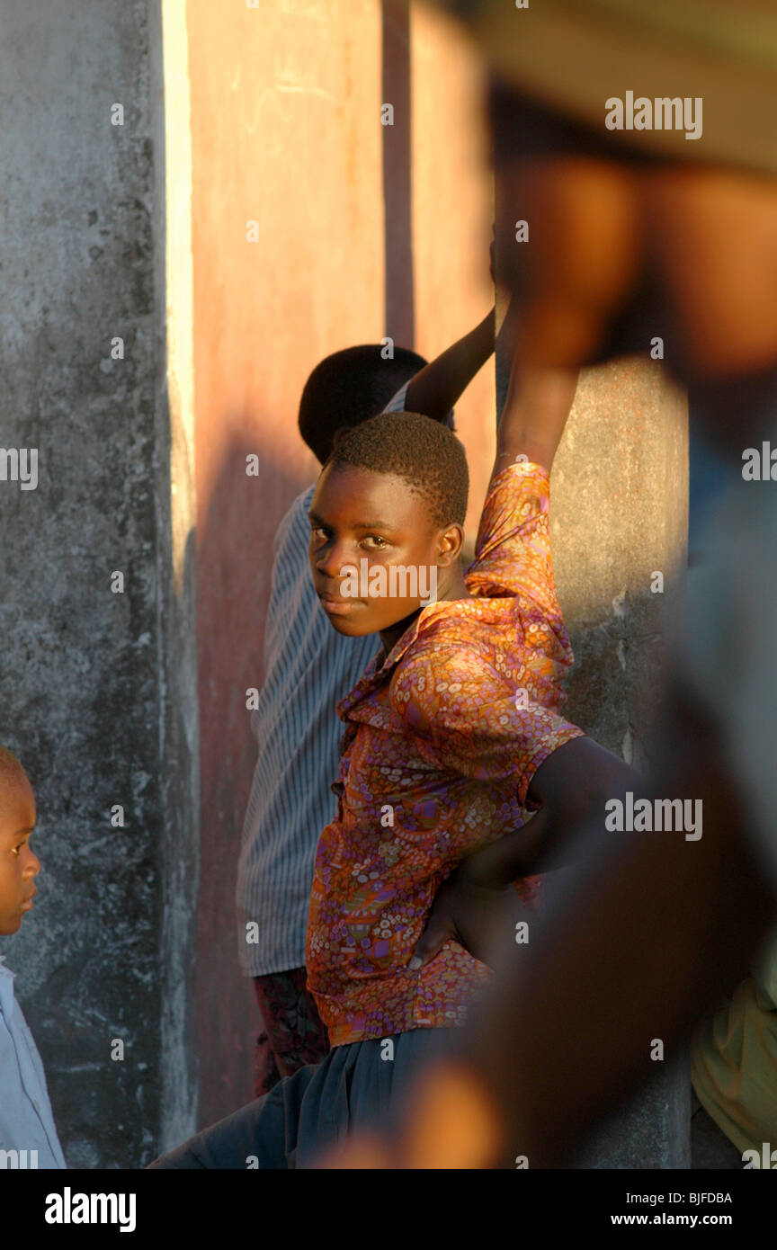 A young man stands in the sunlight by the bar. Ilha De Mocambique ...
