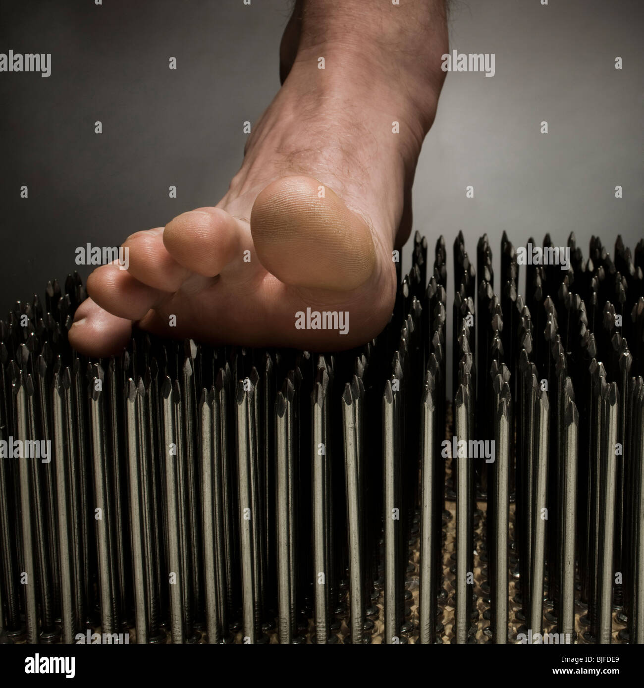 foot walking on nails Stock Photo - Alamy