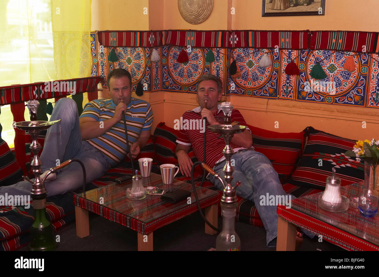Two men smoking a water pipe, Berlin, Germany Stock Photo - Alamy