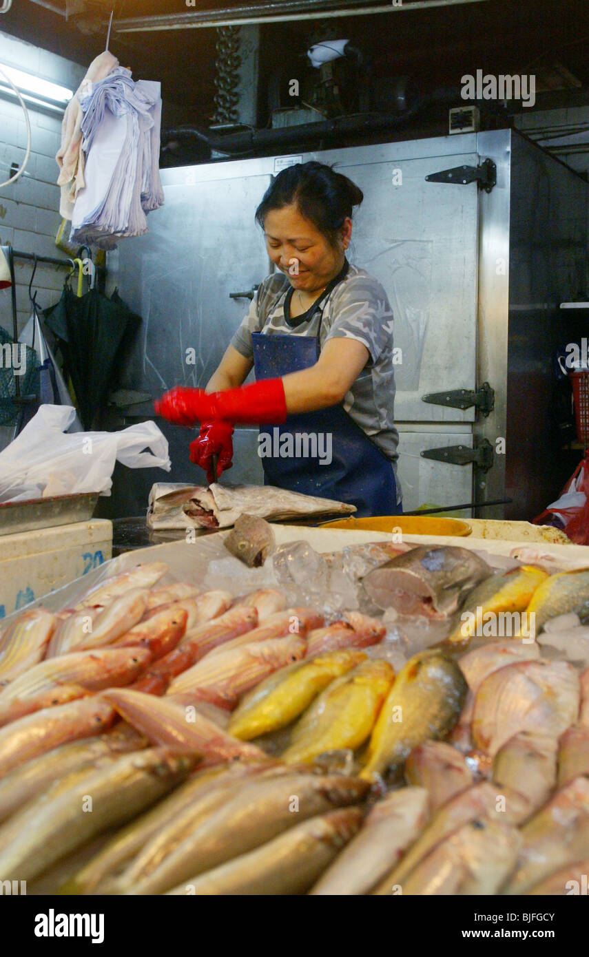 Woman selling fish at a market, Hong Kong, China Stock Photo - Alamy