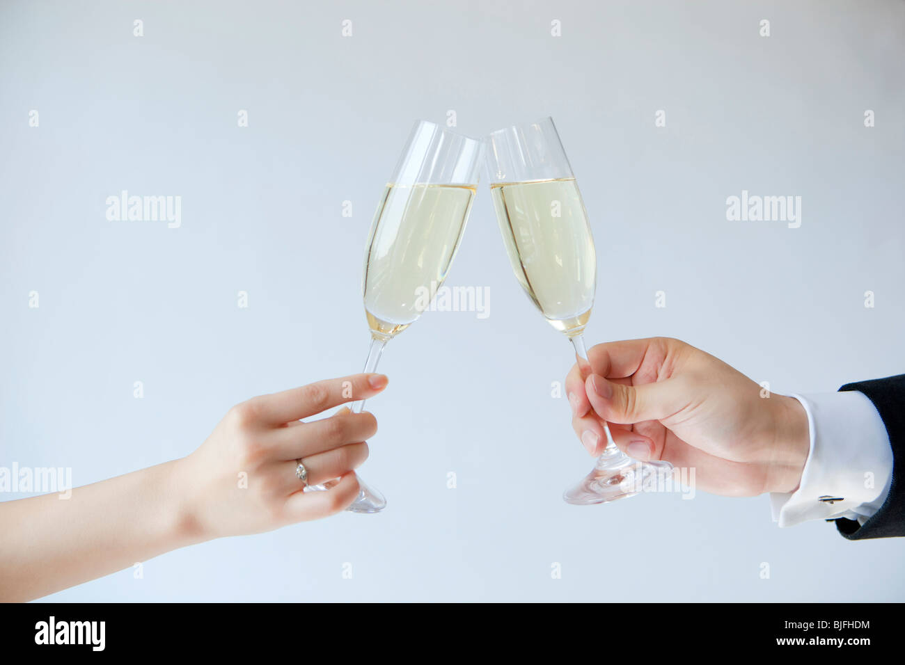 Hands of couple toasting with champagne Stock Photo - Alamy