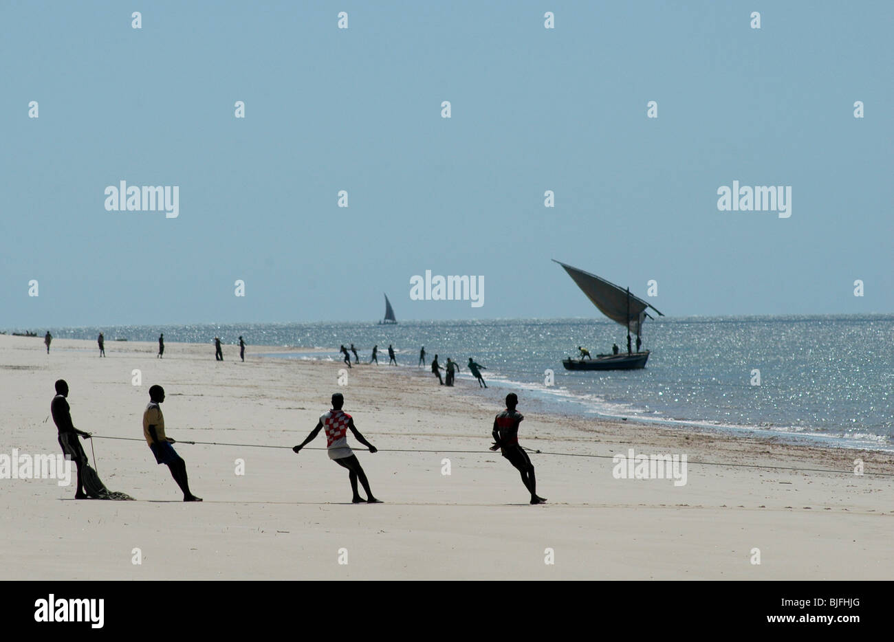 Fishermen pulling nets on beach hi-res stock photography and images - Alamy
