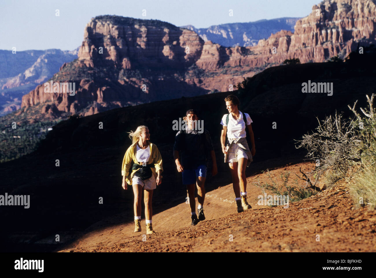 Three hikers on a mountain trail Stock Photo - Alamy