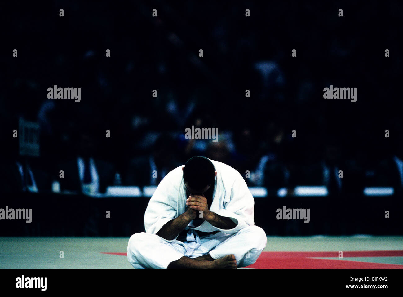 Karate competitor sitting on a mat Stock Photo - Alamy