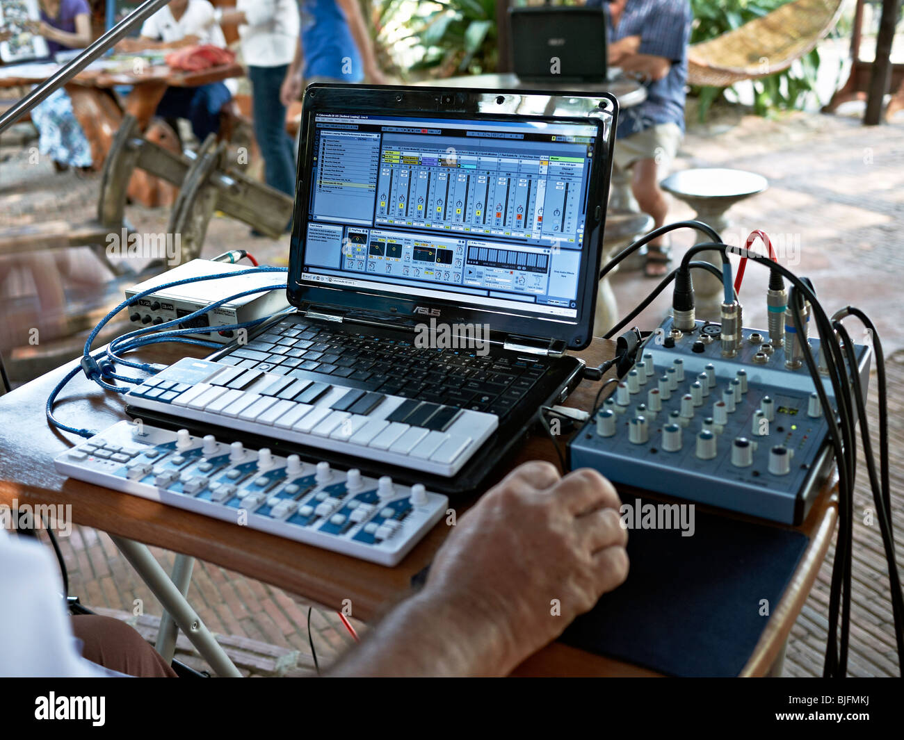 Close up detail of a musician using a computer mixing console and ...