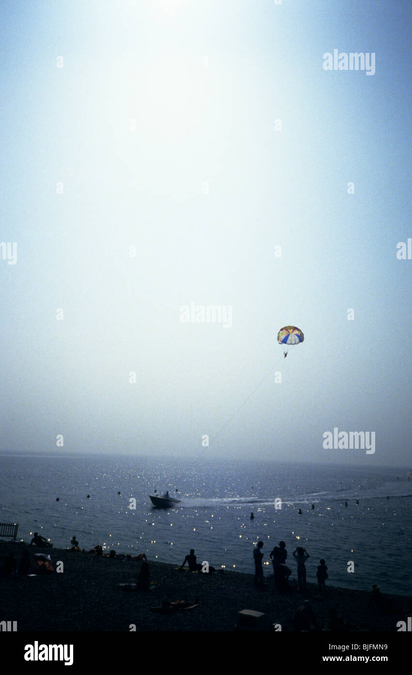 Parachute flying over coastal area Stock Photo - Alamy
