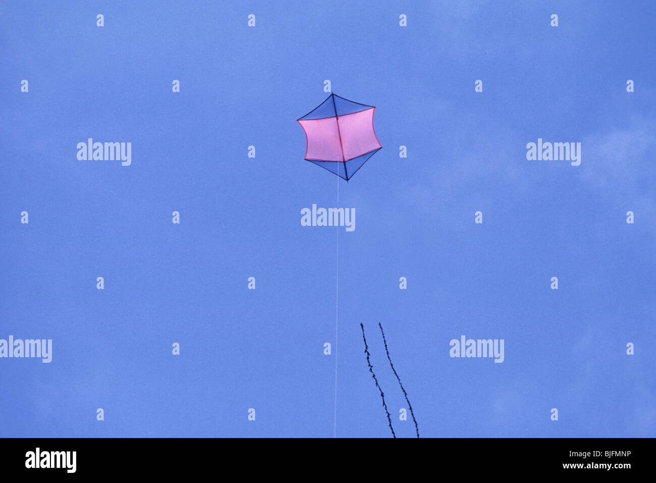 Kite flying high in sky Stock Photo - Alamy