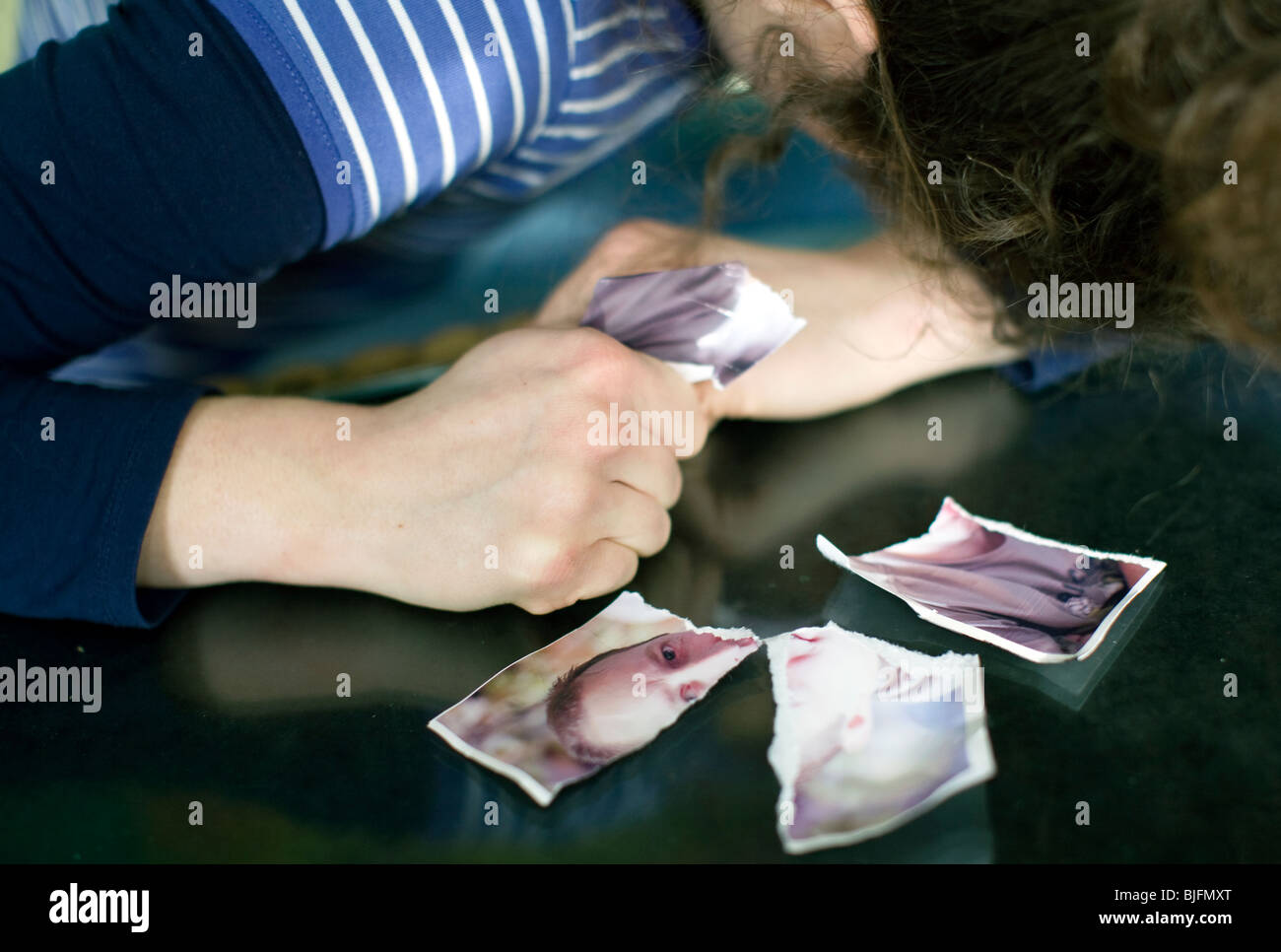 Tearing up photo of ex-boyfriend etc: MODEL RELEASED Stock Photo - Alamy