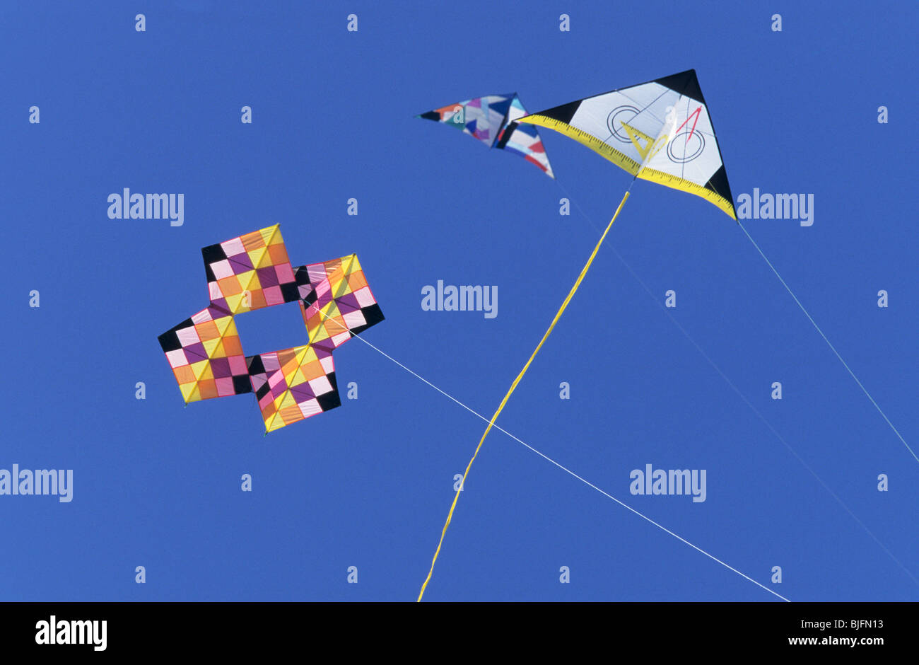 Colourful kites flying high in sky Stock Photo - Alamy