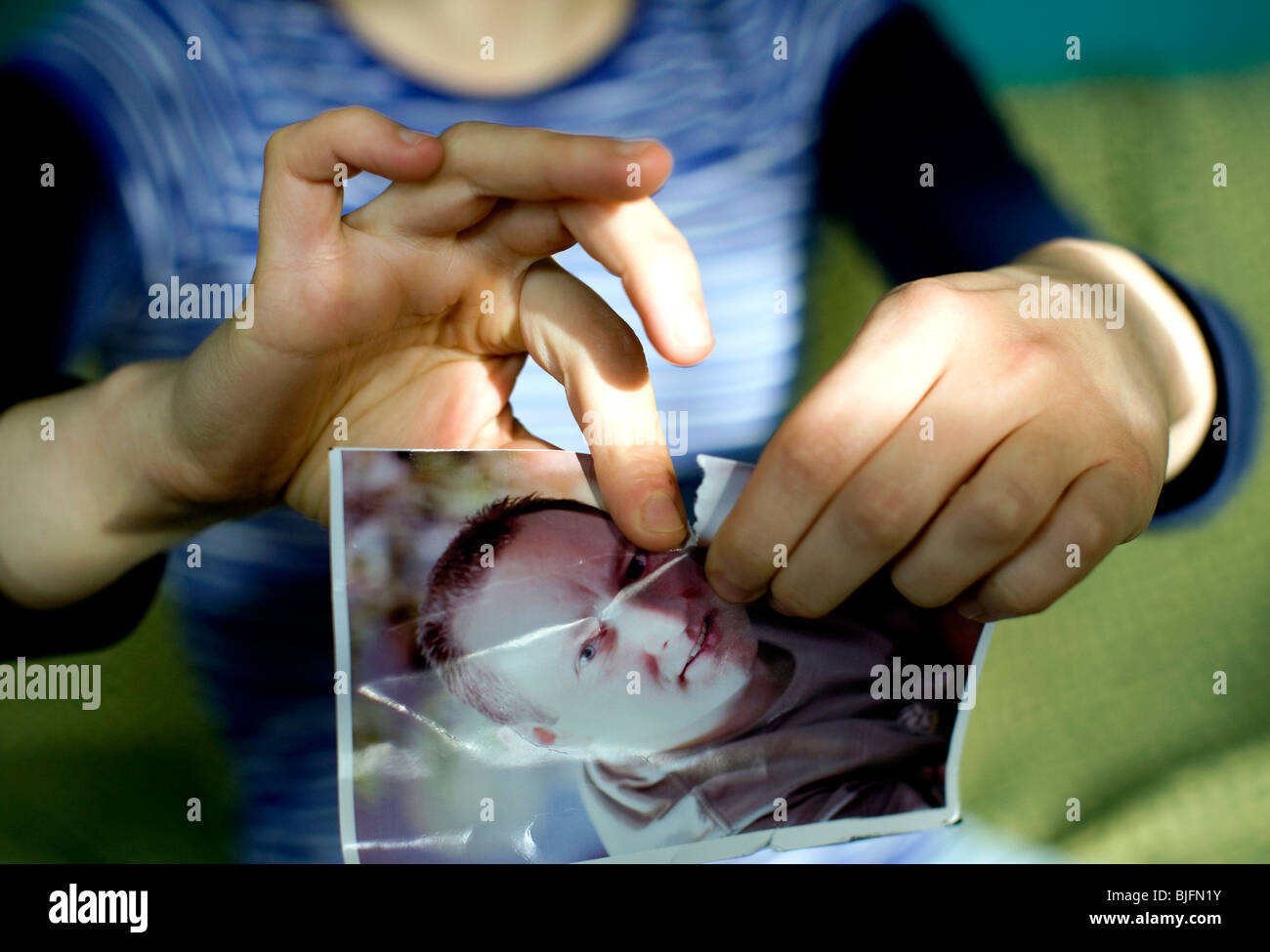 Tearing up photo of ex-boyfriend etc: MODEL RELEASED Stock Photo - Alamy