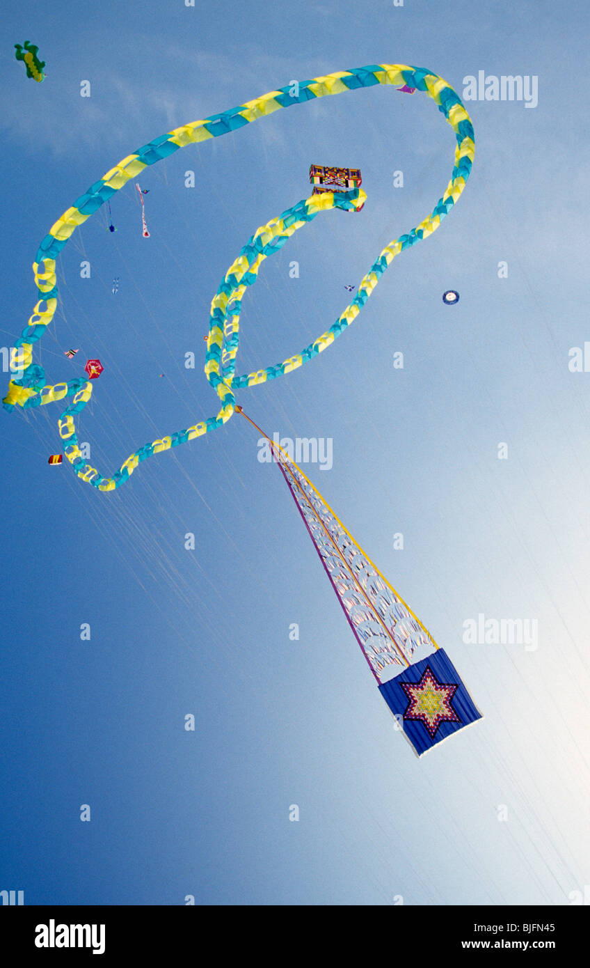 Colourful figure kites flying high in sky Stock Photo - Alamy