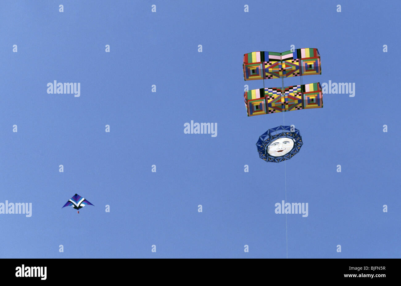 Colourful figure kites flying high in sky Stock Photo - Alamy