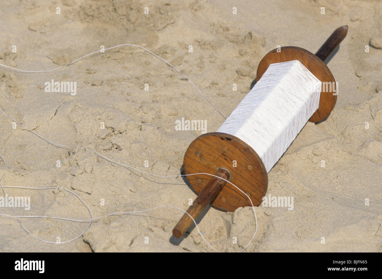 Kite spool laying on the beach Stock Photo - Alamy