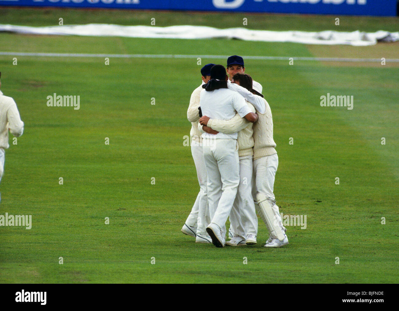 Cricketers celebrating with a group huddle Stock Photo - Alamy