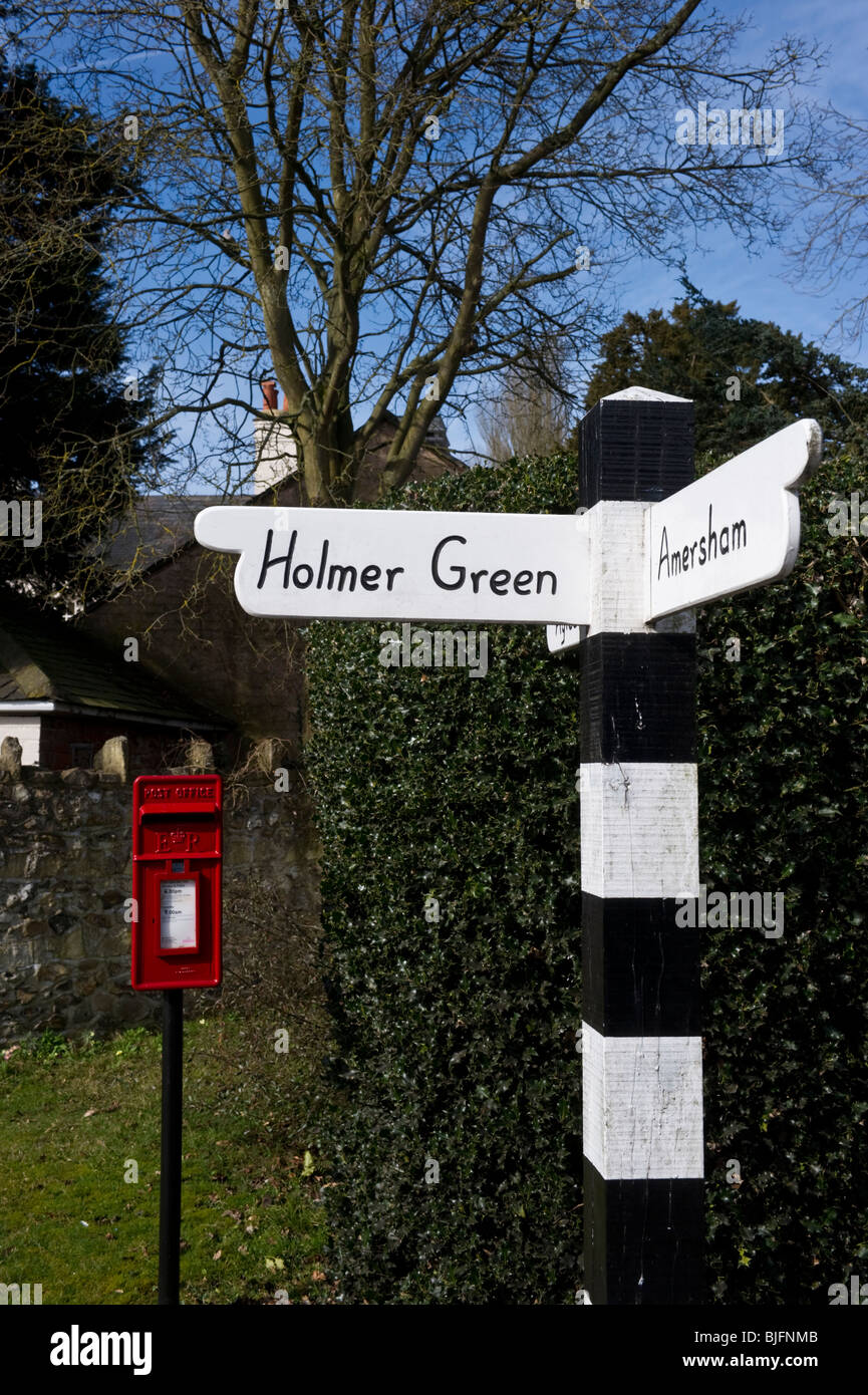 traditional village signpost and red letter box in Little Missenden ...