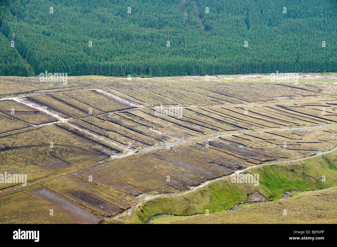 Peat being stripped from a valley floor, Partry Mountains, County Mayo ...